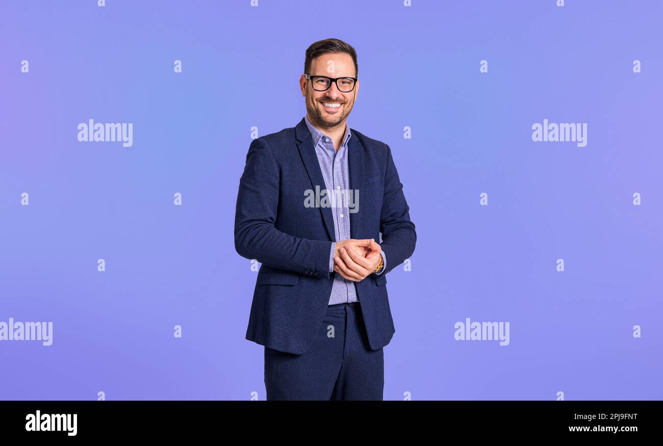 Smiling elegant mid adult male manager dressed in blue suit clasping ...