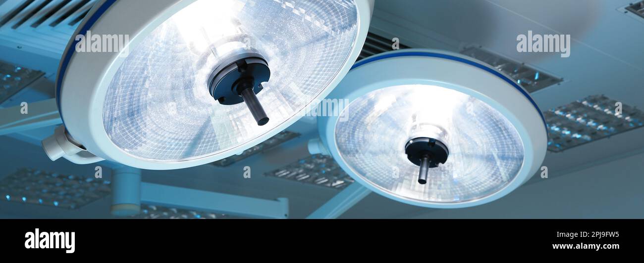Powerful surgical lamps in modern operating room, closeup. Banner ...