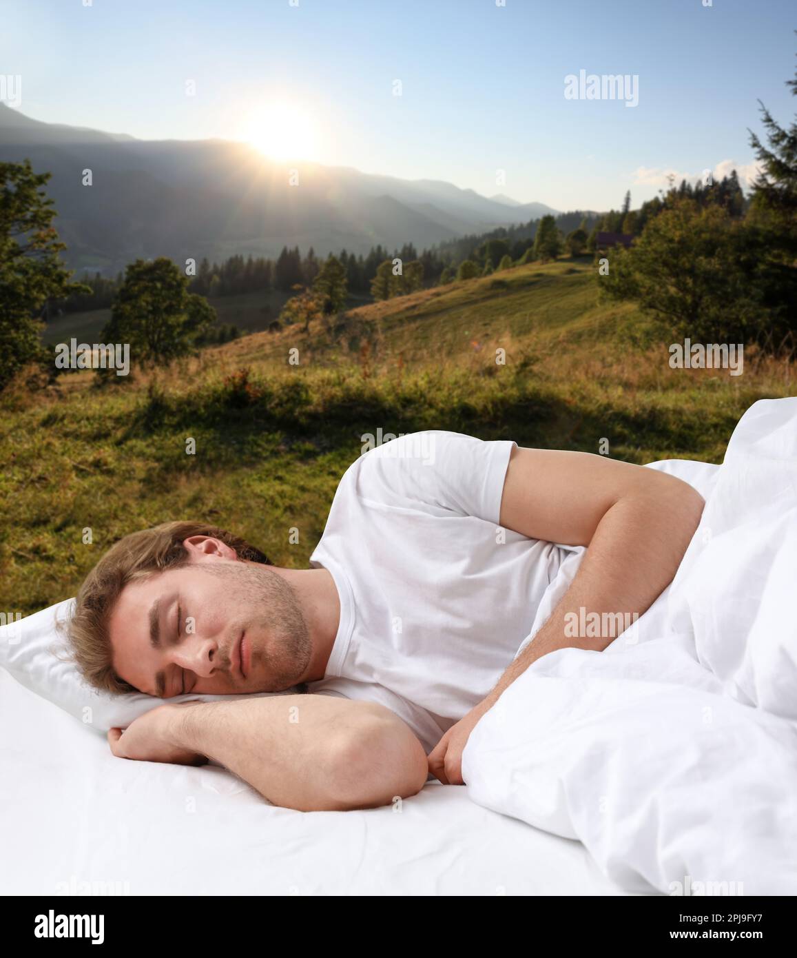 Man sleeping in bed and beautiful view of mountain landscape on ...