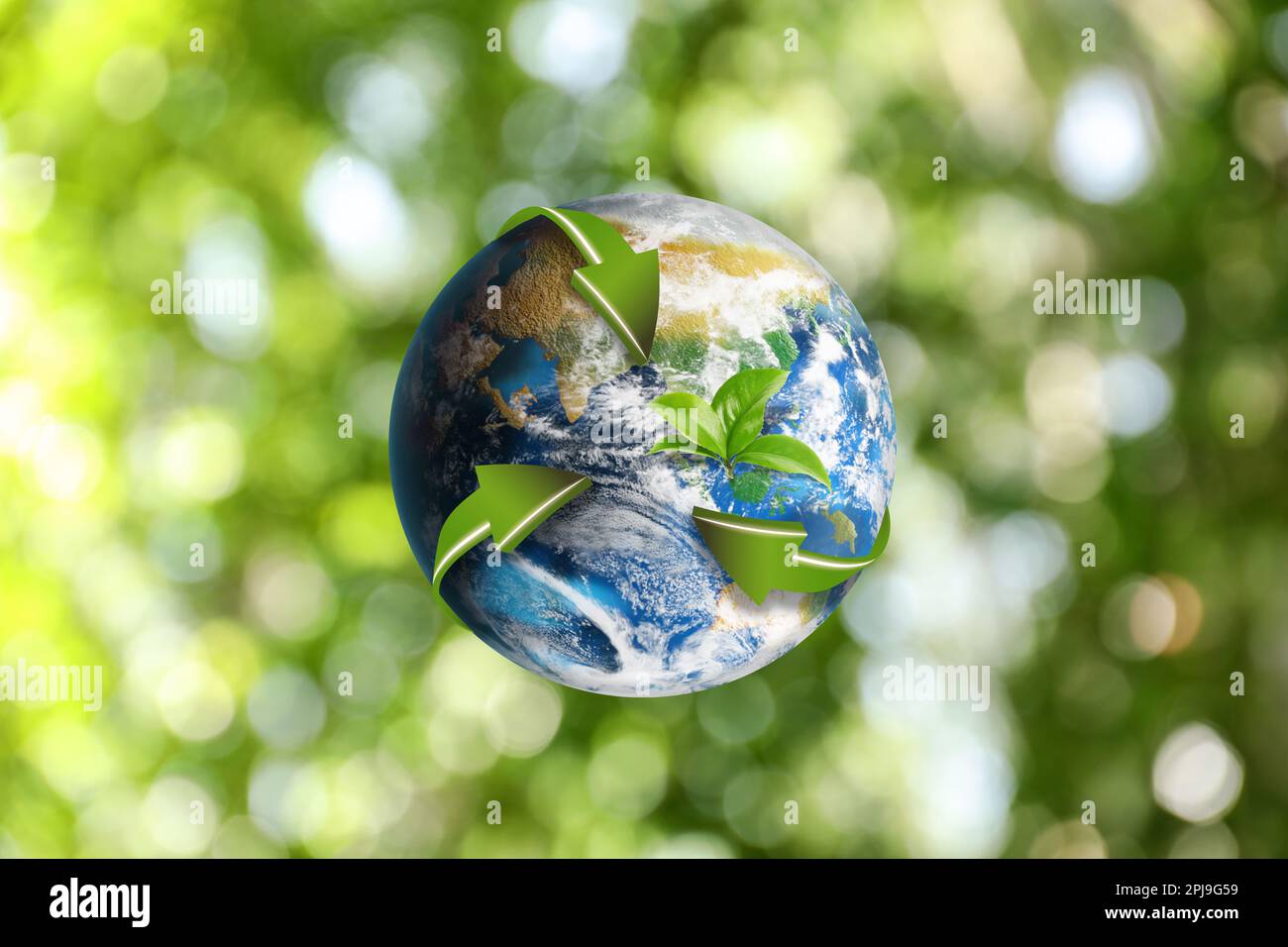 Recycling concept. Earth planet with green arrows and leaves on blurred ...