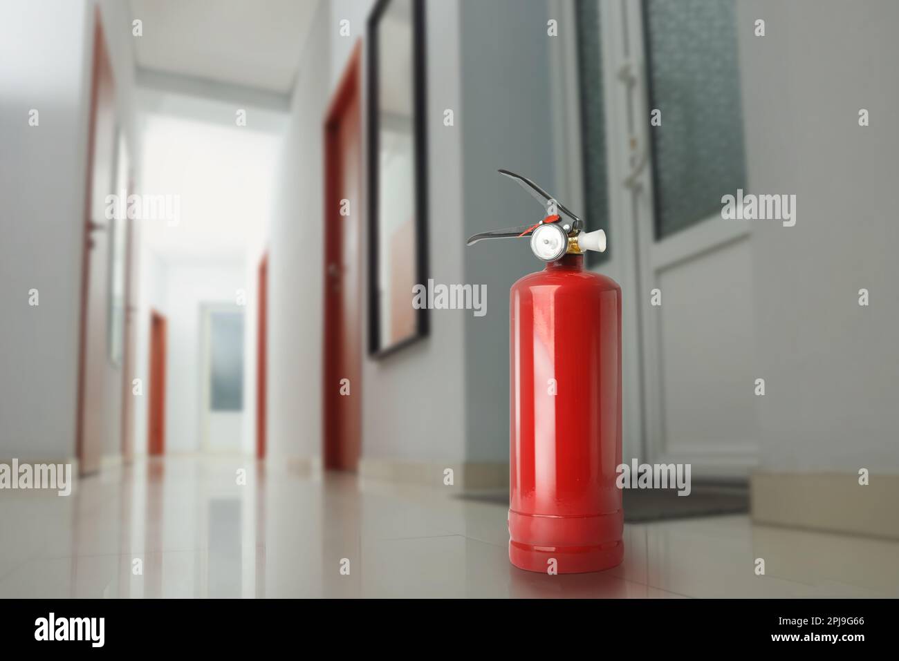 Fire extinguisher on floor in office corridor. Space for text Stock ...