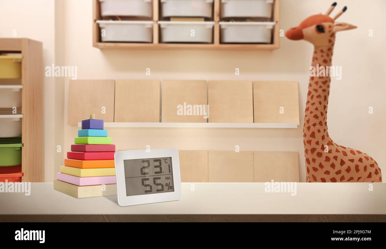 Digital hygrometer with thermometer on table in children's room ...
