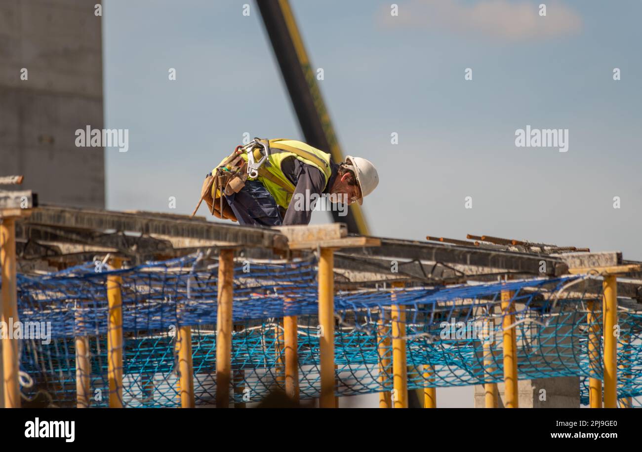 Labourer working on new modern high rise building hi-res stock ...