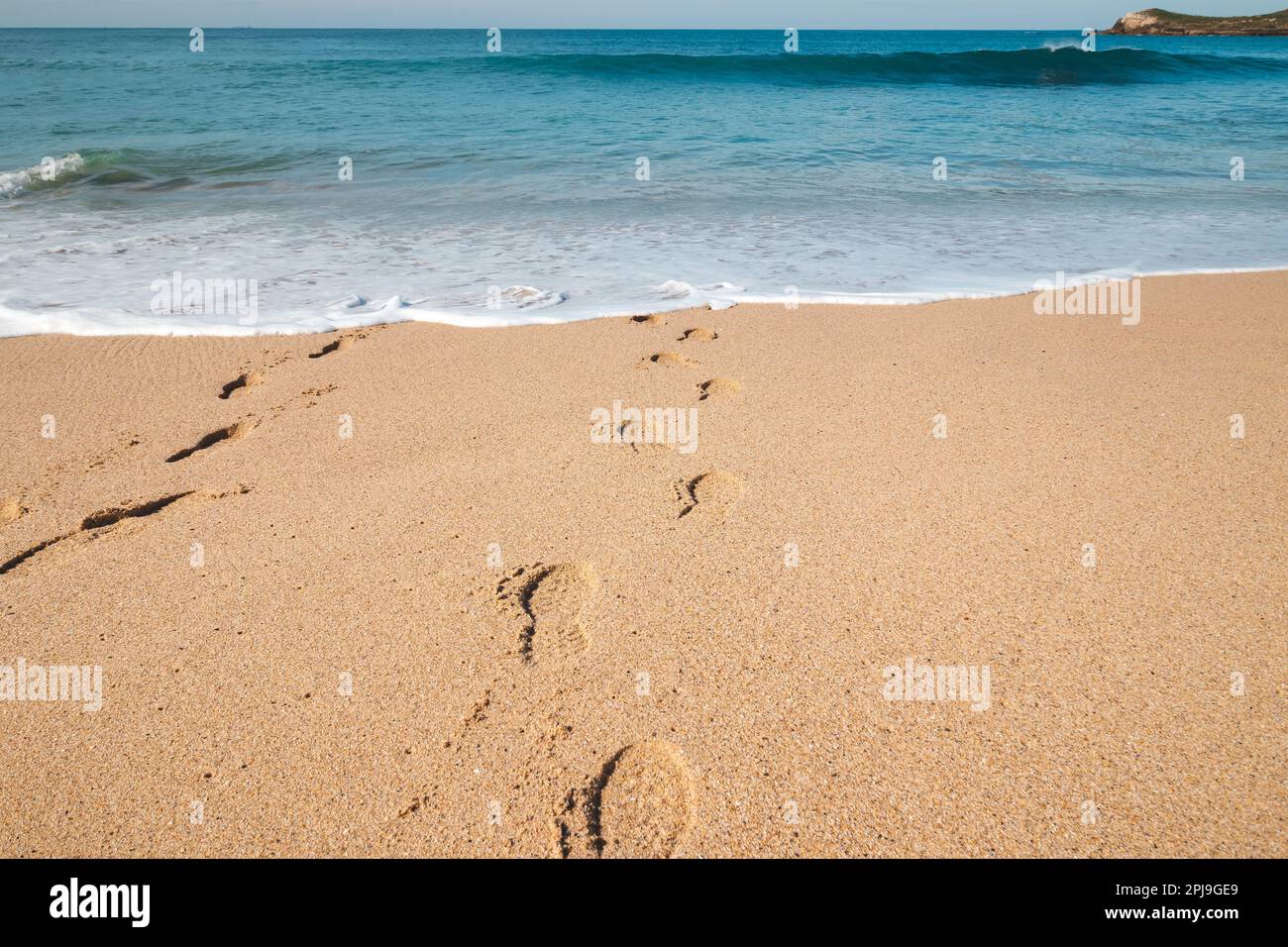 Footprints in the sand from a man sinking into the deep Atlantic Ocean ...