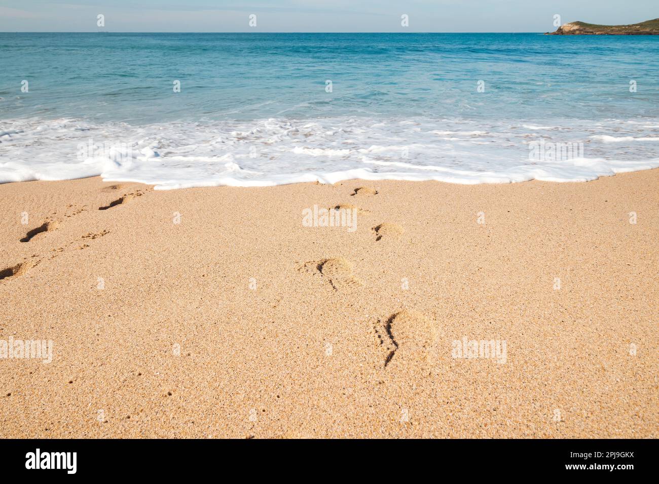 Footprints in the sand from a man sinking into the deep Atlantic Ocean ...