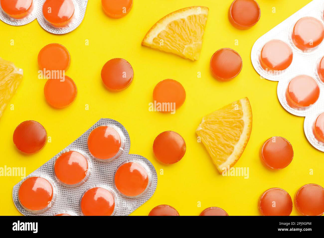 Many orange cough drops on pink background, flat lay Stock Photo - Alamy