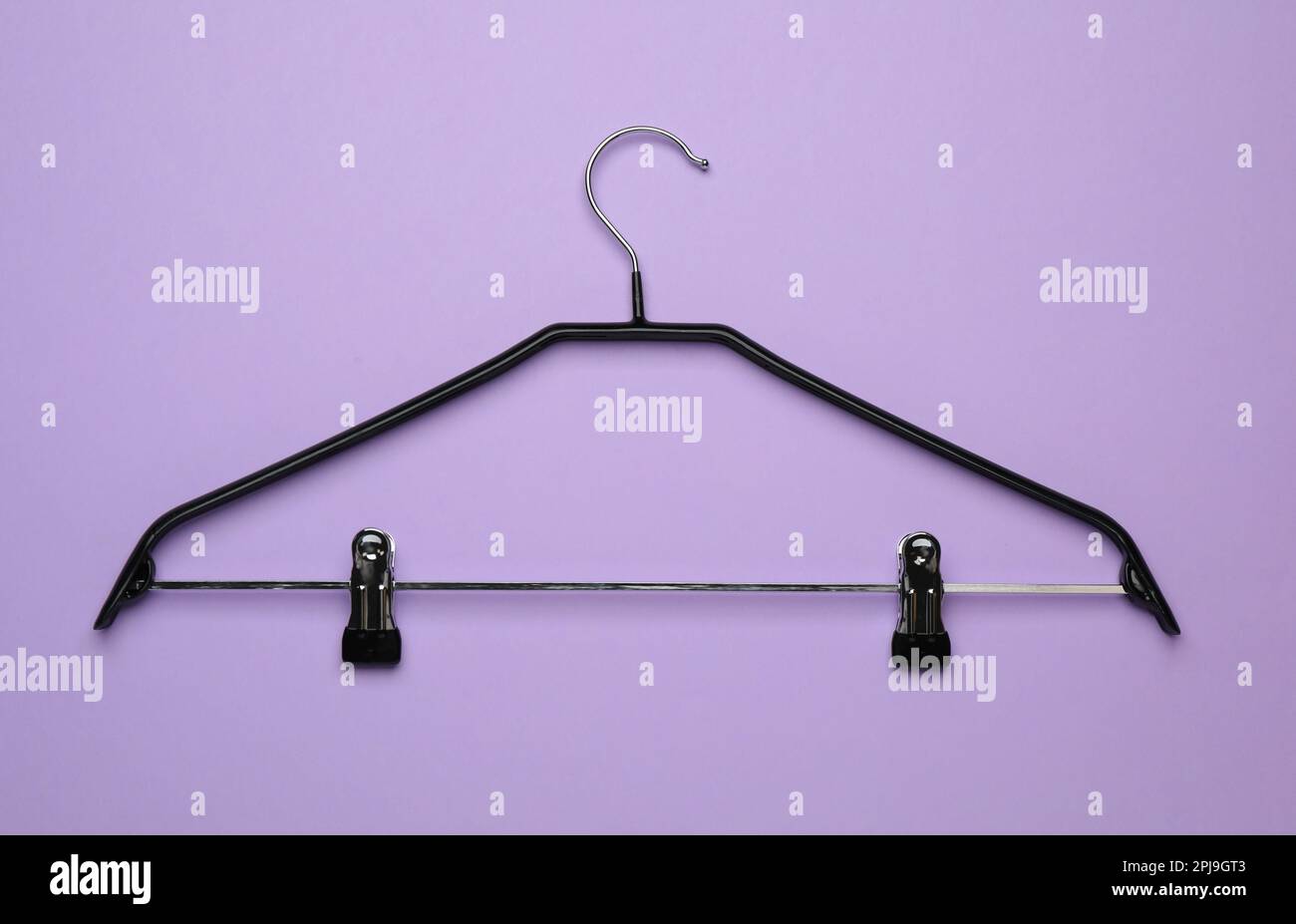 Empty clothes hanger on violet background, top view Stock Photo - Alamy