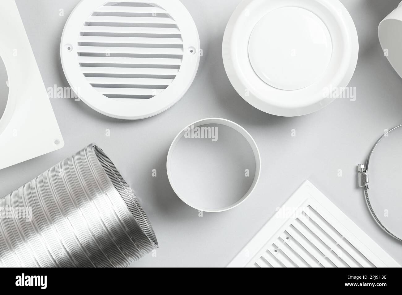 Parts of home ventilation system on light grey background, flat lay ...