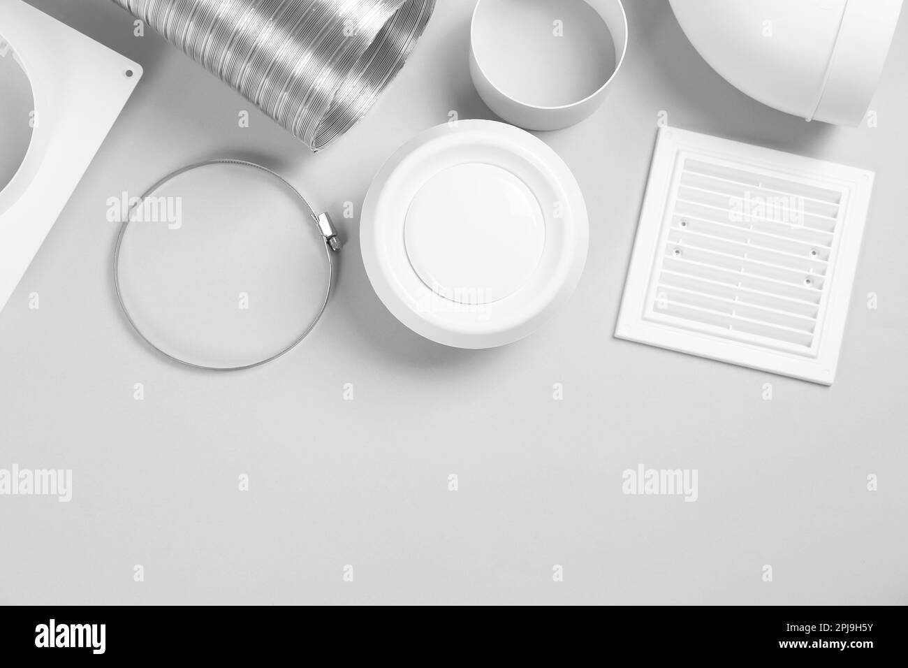 Parts of home ventilation system on light grey background, flat lay ...