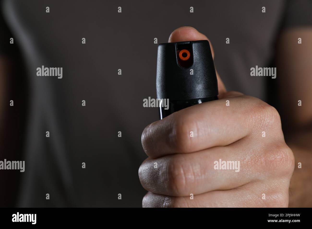 Man using pepper spray, closeup. Space for text Stock Photo - Alamy