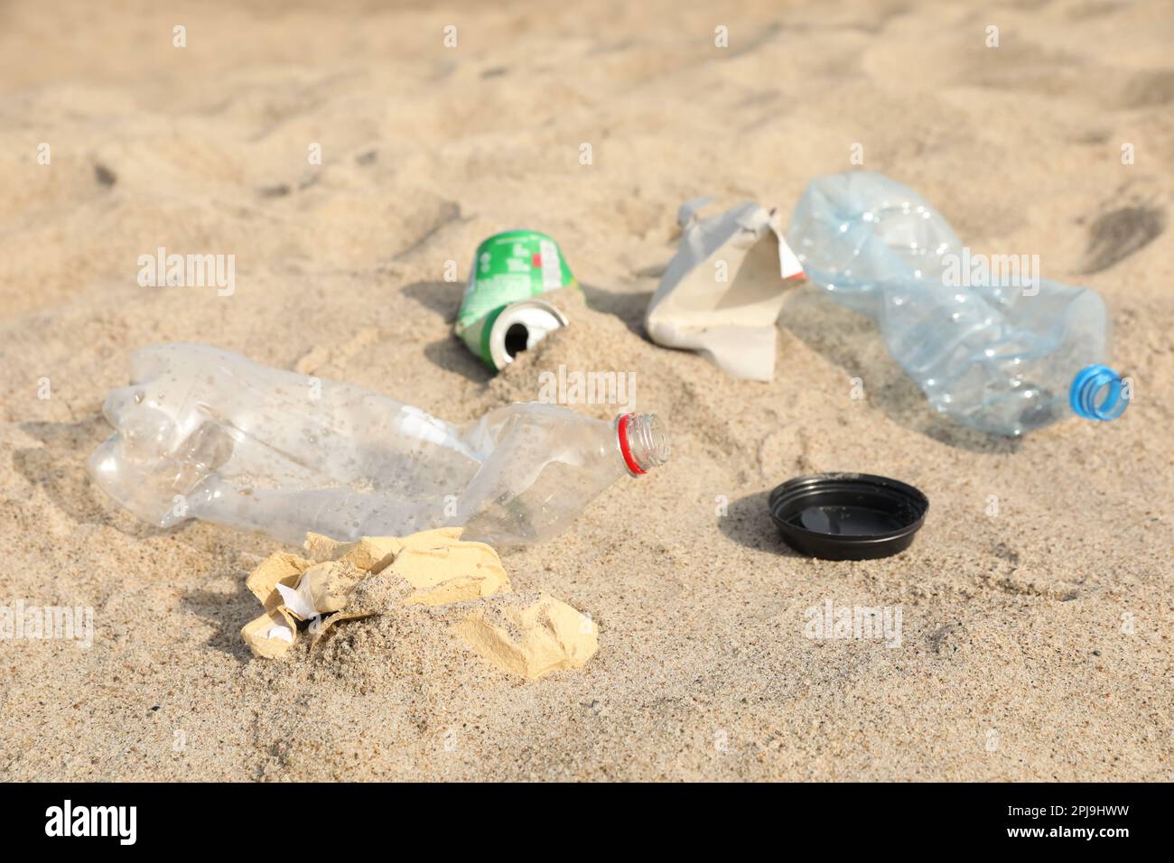 Different garbage scattered on sand. Recycling problem Stock Photo - Alamy