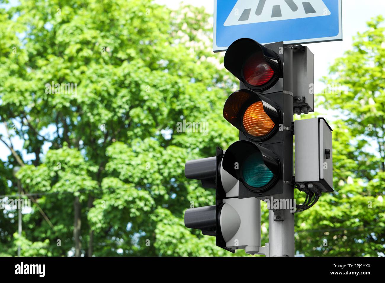 Post with traffic lights and Pedestrian Crossing road sign outdoors ...