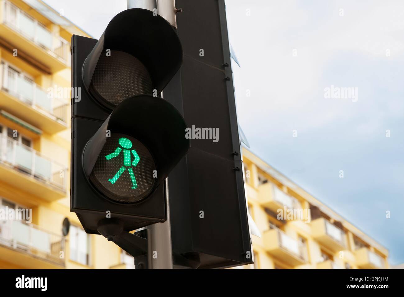Post with pedestrian traffic light in city Stock Photo - Alamy