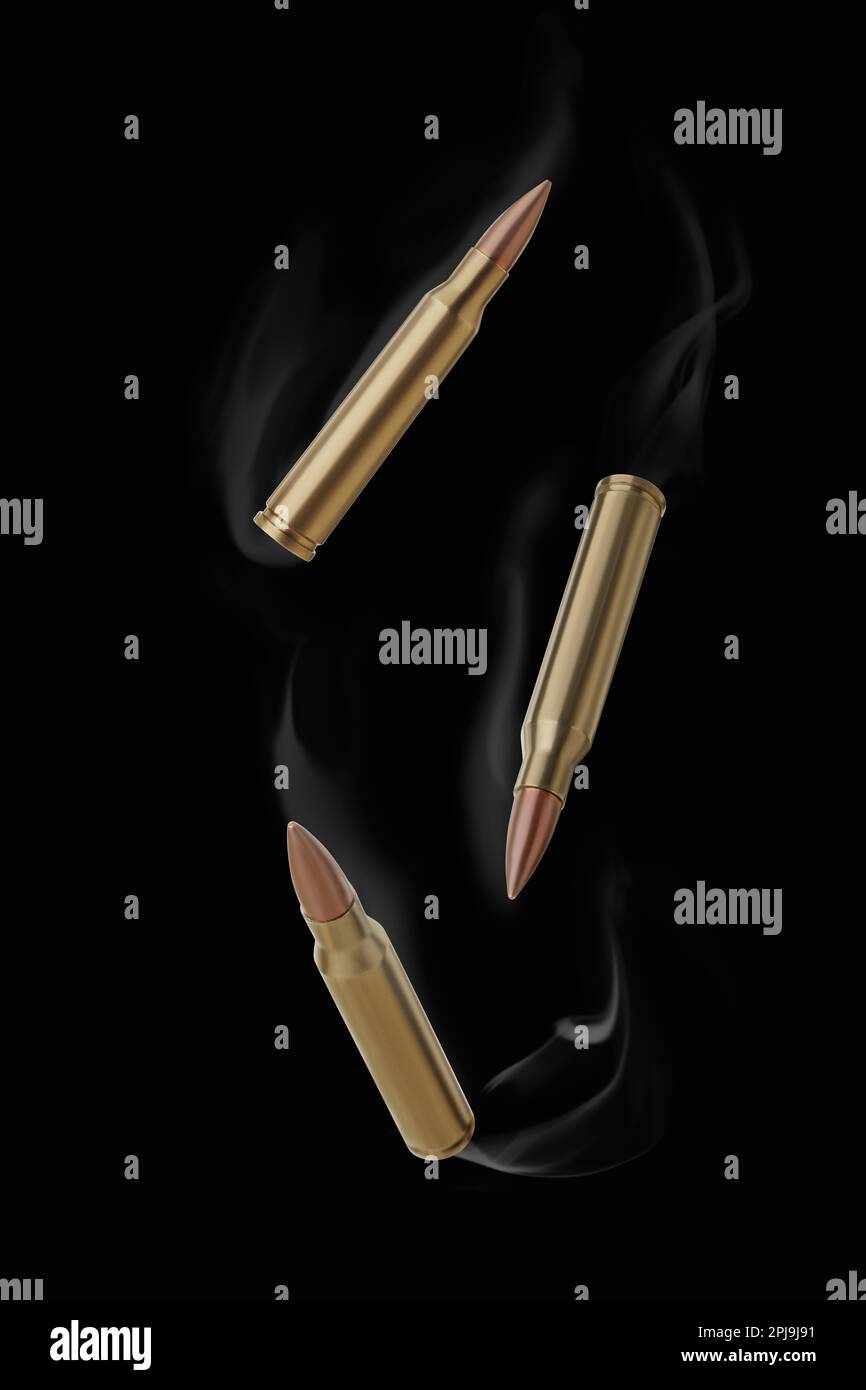 Bullets with smoke falling on black background Stock Photo - Alamy