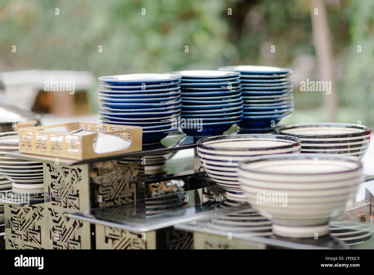 An outdoor buffet featuring a variety of vibrant colored dishes set up ...