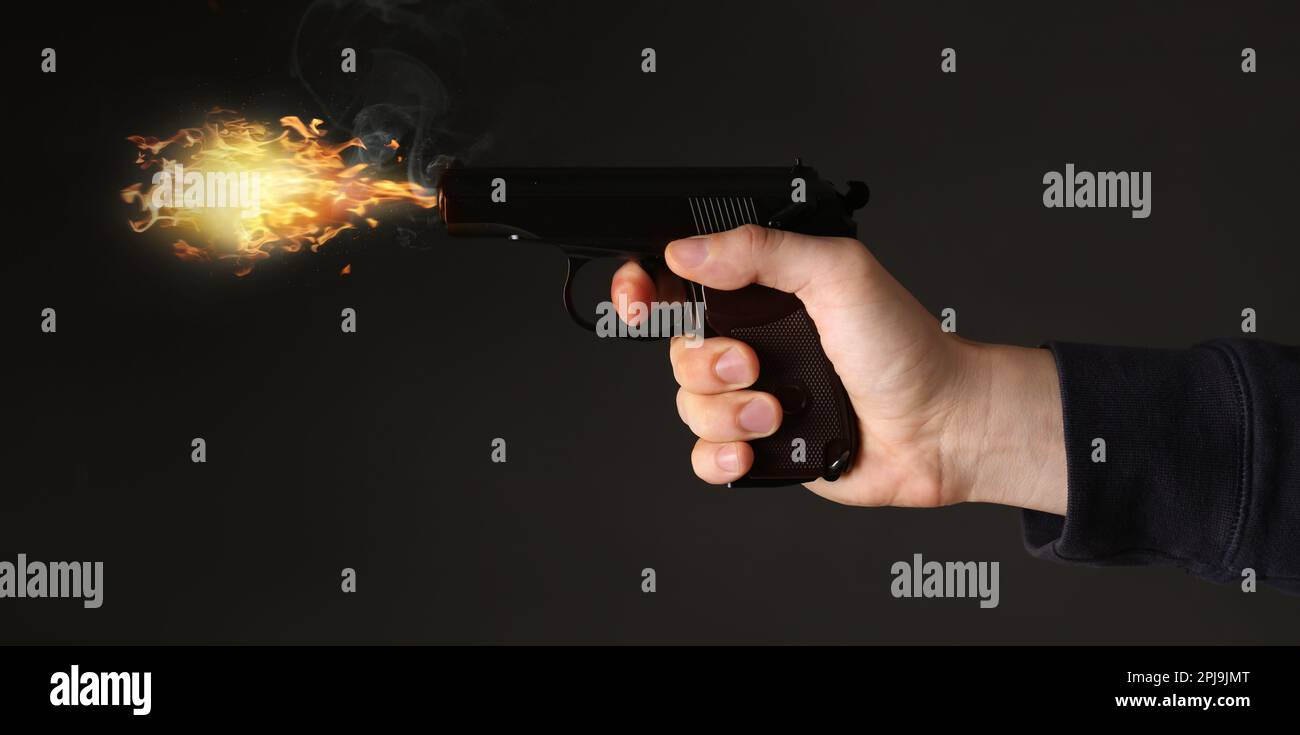 Man shooting handgun on black background, closeup. Banner design Stock ...
