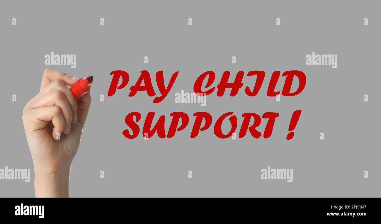 Woman with marker and phrase PAY CHILD SUPPORT! on light grey ...