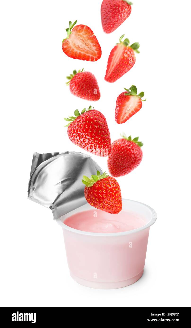 Many fresh red strawberries falling into plastic cup with yogurt on white background Stock Photo ...