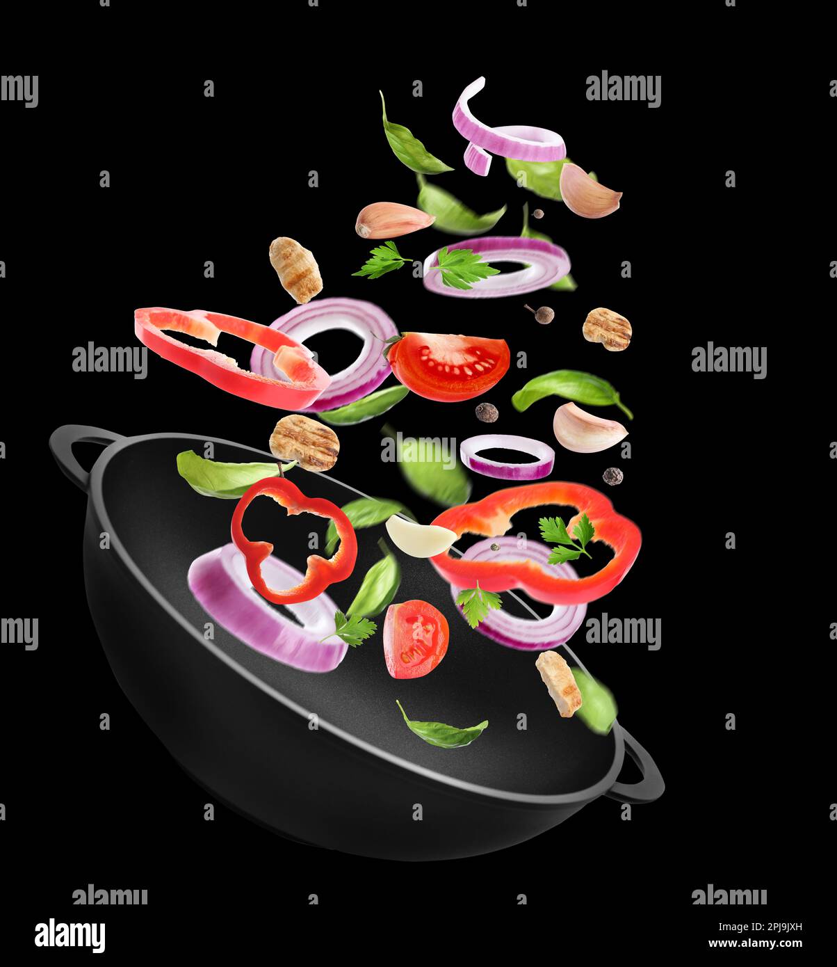 Different tasty ingredients falling into wok on black background Stock ...
