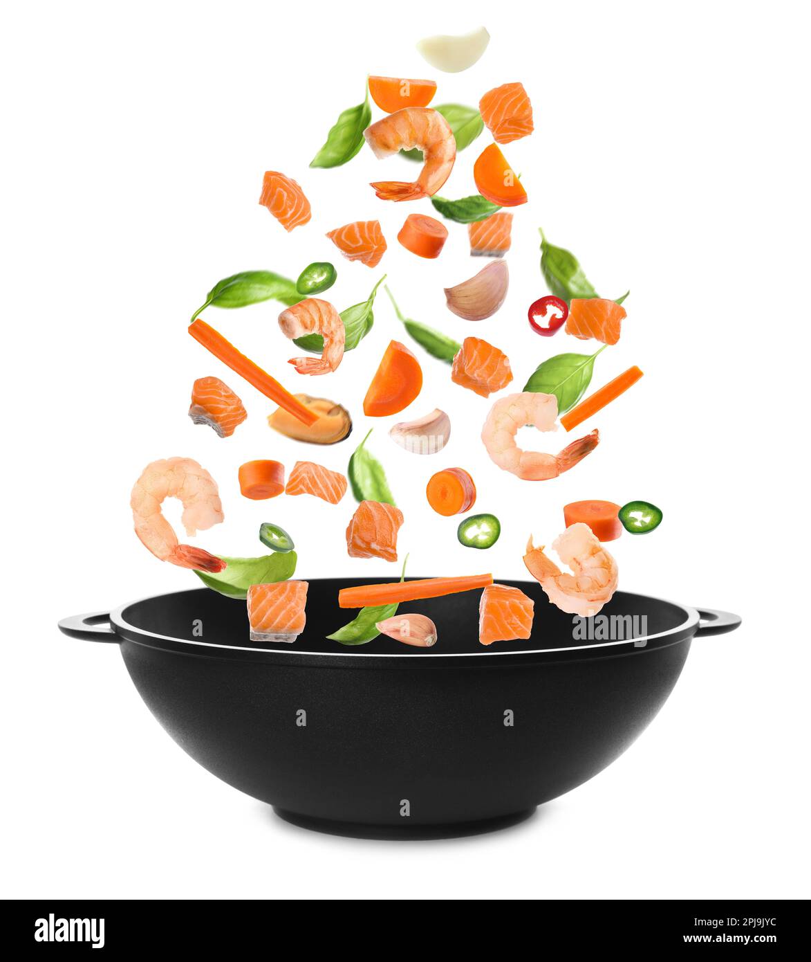 Different tasty ingredients falling into wok on white background Stock ...