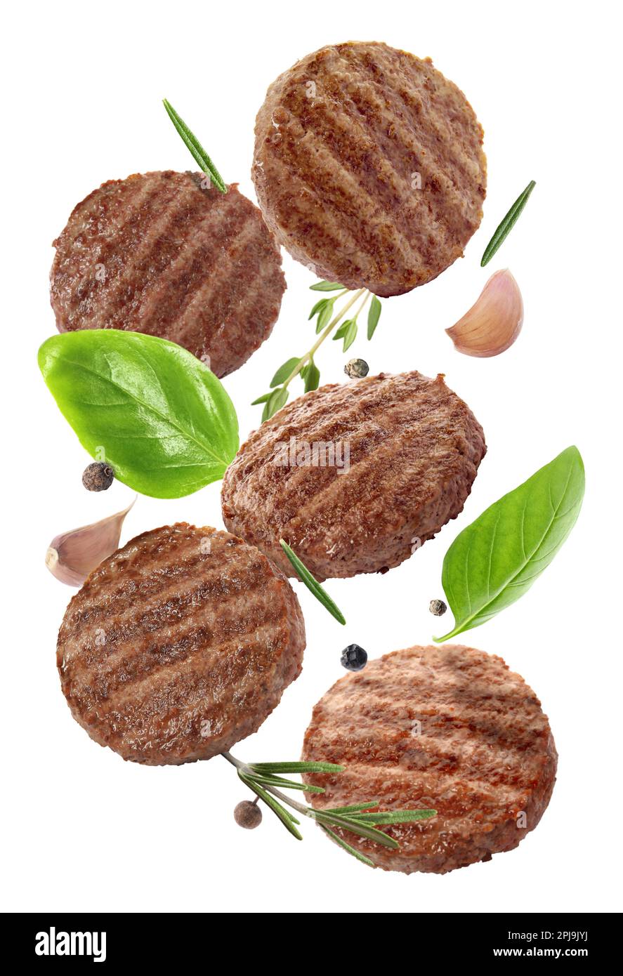 Tasty grilled hamburger patties and spices falling on white background ...