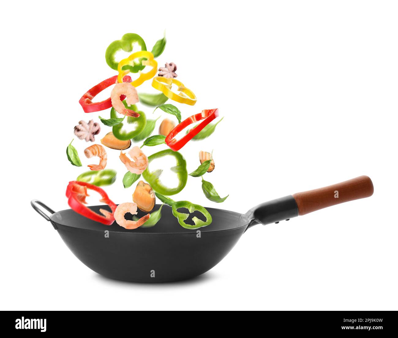 Different tasty ingredients falling into wok on white background Stock ...