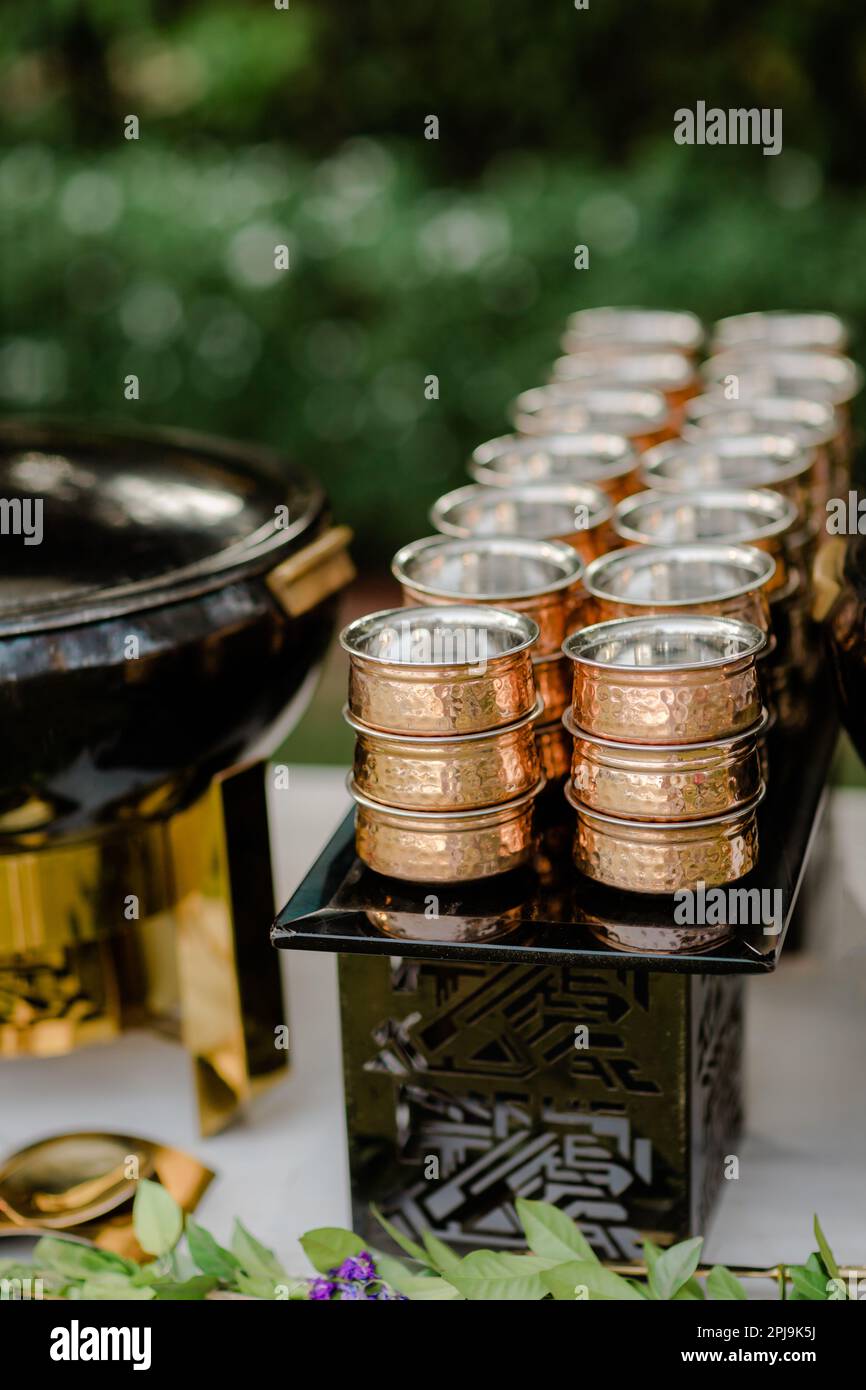 An outdoor buffet featuring a variety of vibrant colored dishes set up ...