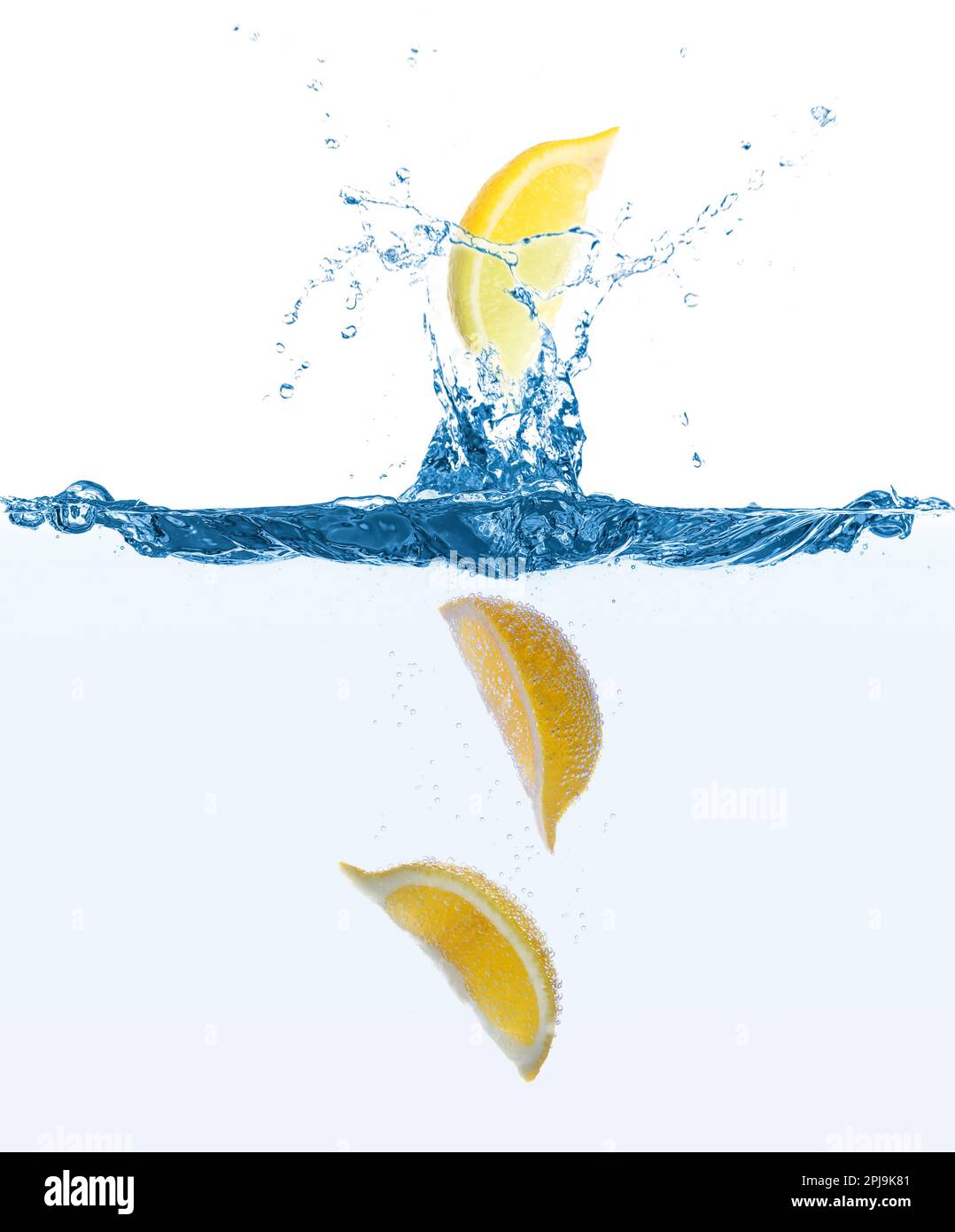 Fresh ripe lemon falling into water with splashes on white background ...