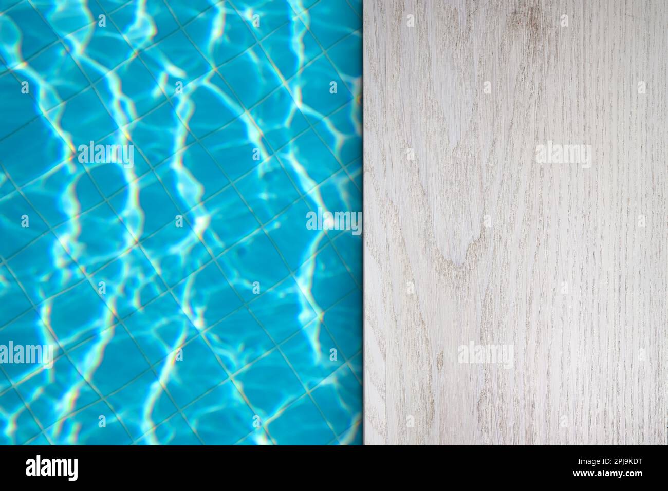 Empty white wooden surface near swimming pool with clear water. Space ...