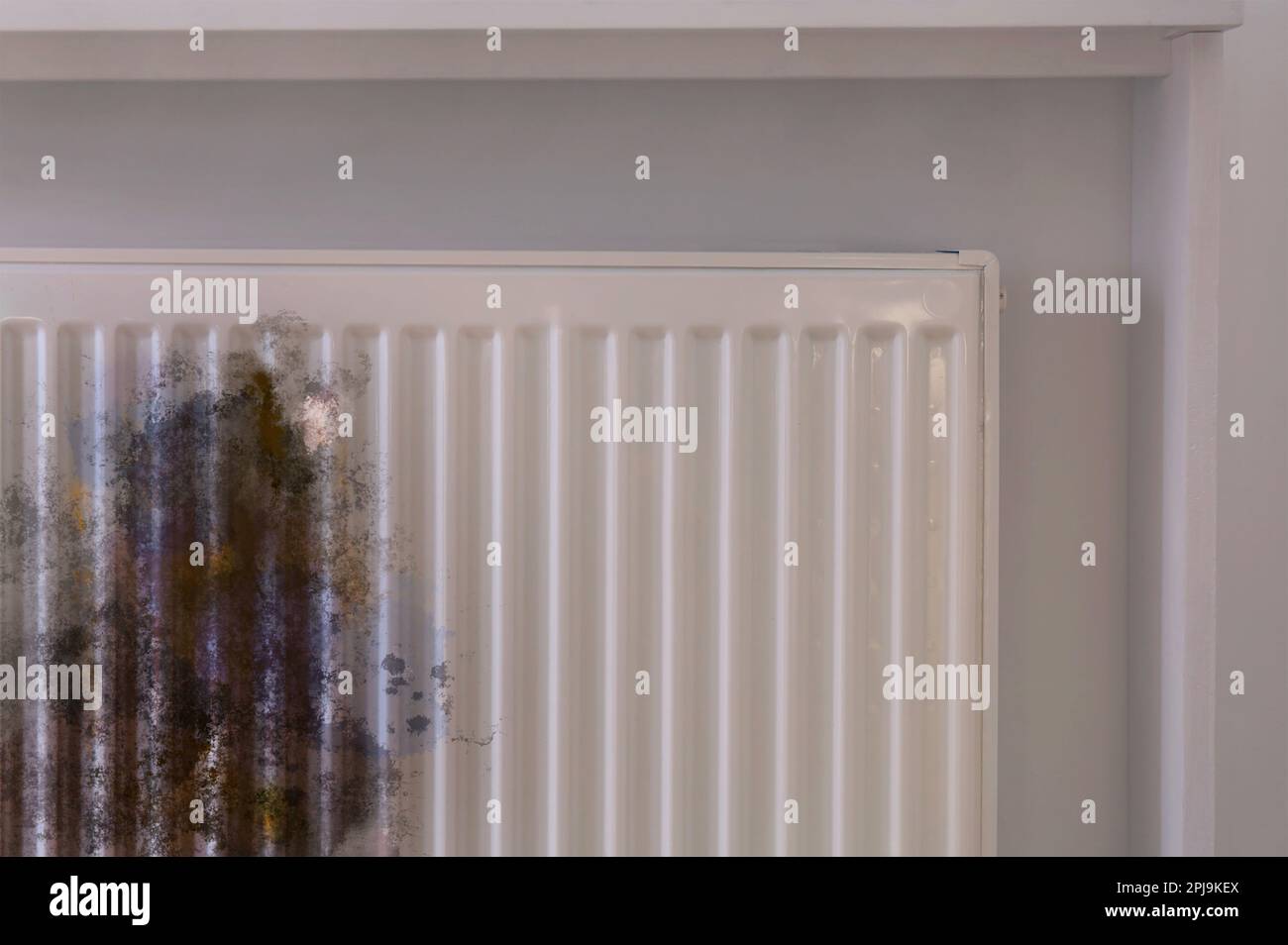 Modern panel radiator affected by rust indoors Stock Photo - Alamy