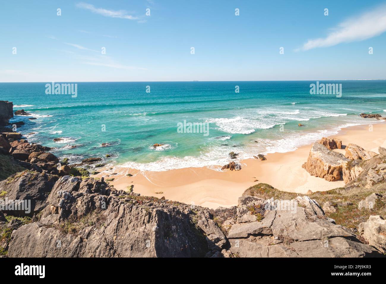 Rocks surround the sandy beach of Praia do Malhao Sul on the Atlantic ...