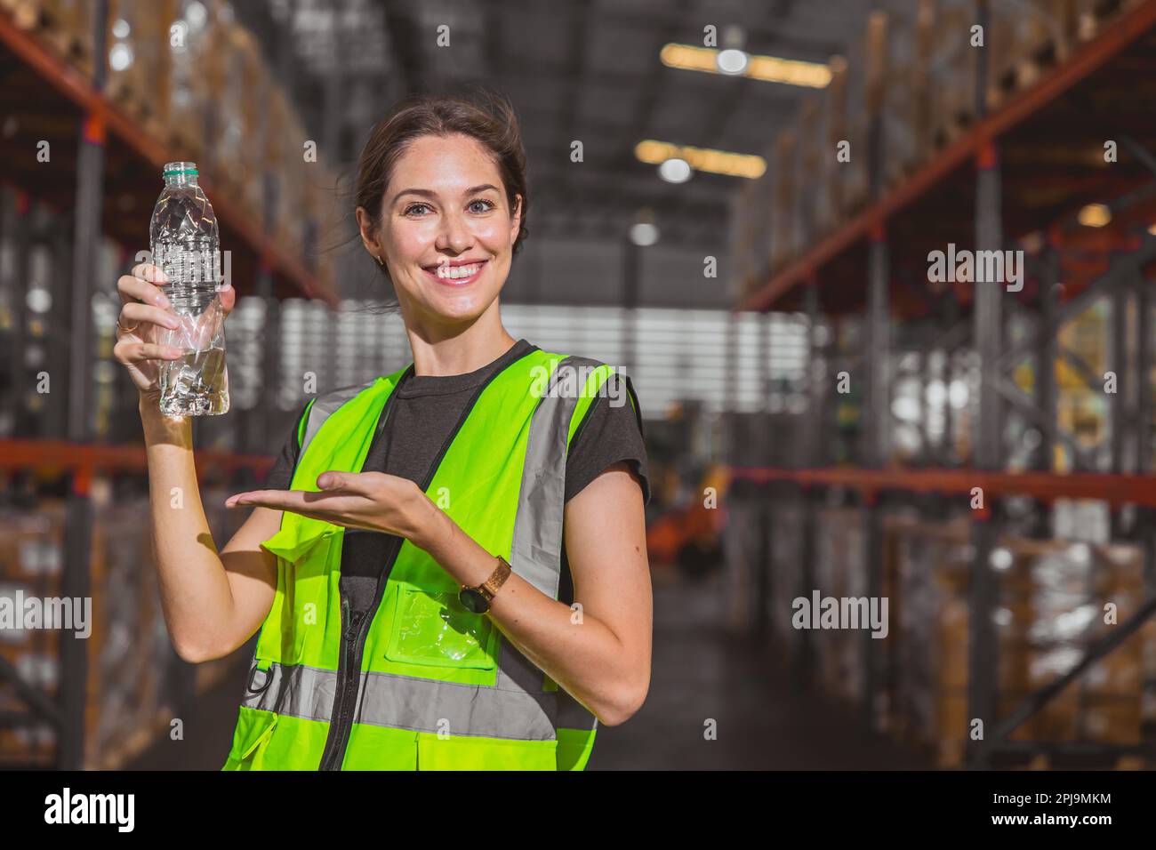 happy worker with drinking water bottle present drink clean water for fresh and healthy work in ...
