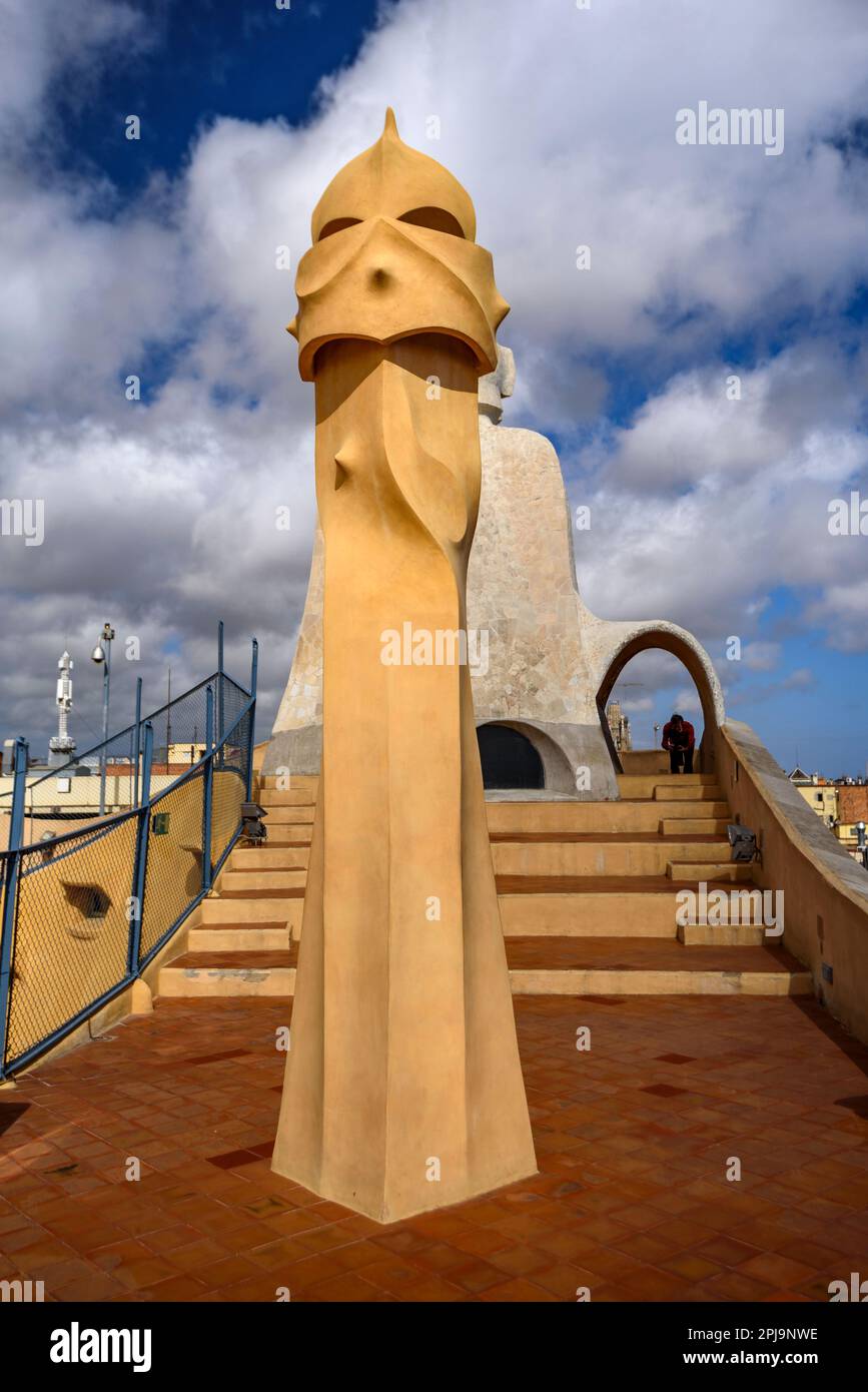 Rooftop chimneys of Casa Milà - La Pedrera with the Sagrada Familia in ...