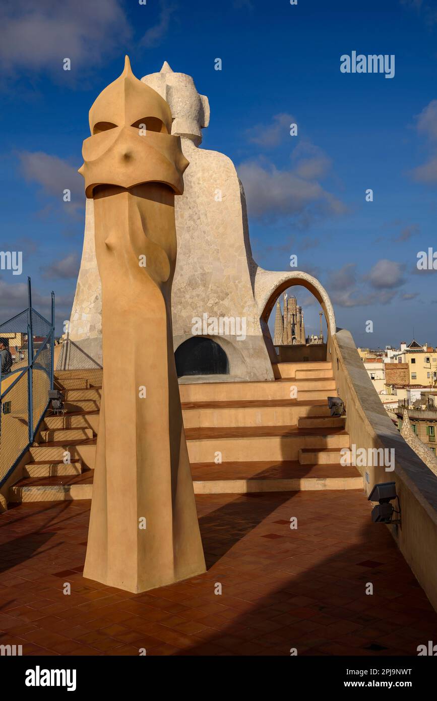 Rooftop chimneys of Casa Milà - La Pedrera with the Sagrada Familia in ...