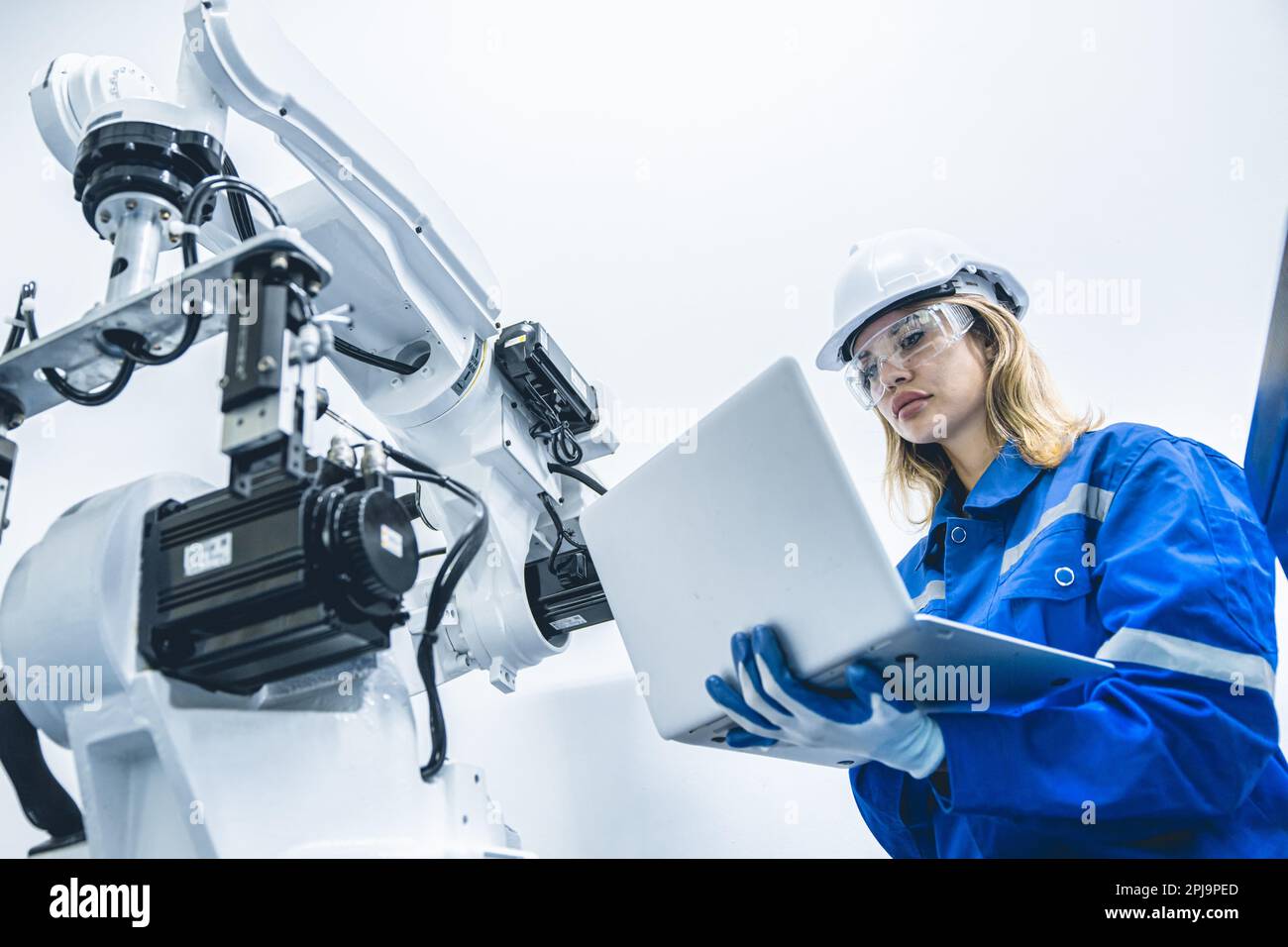 engineer woman worker working with robotic arm in productions lab ... engineer woman worker working with robotic arm in productions lab ...