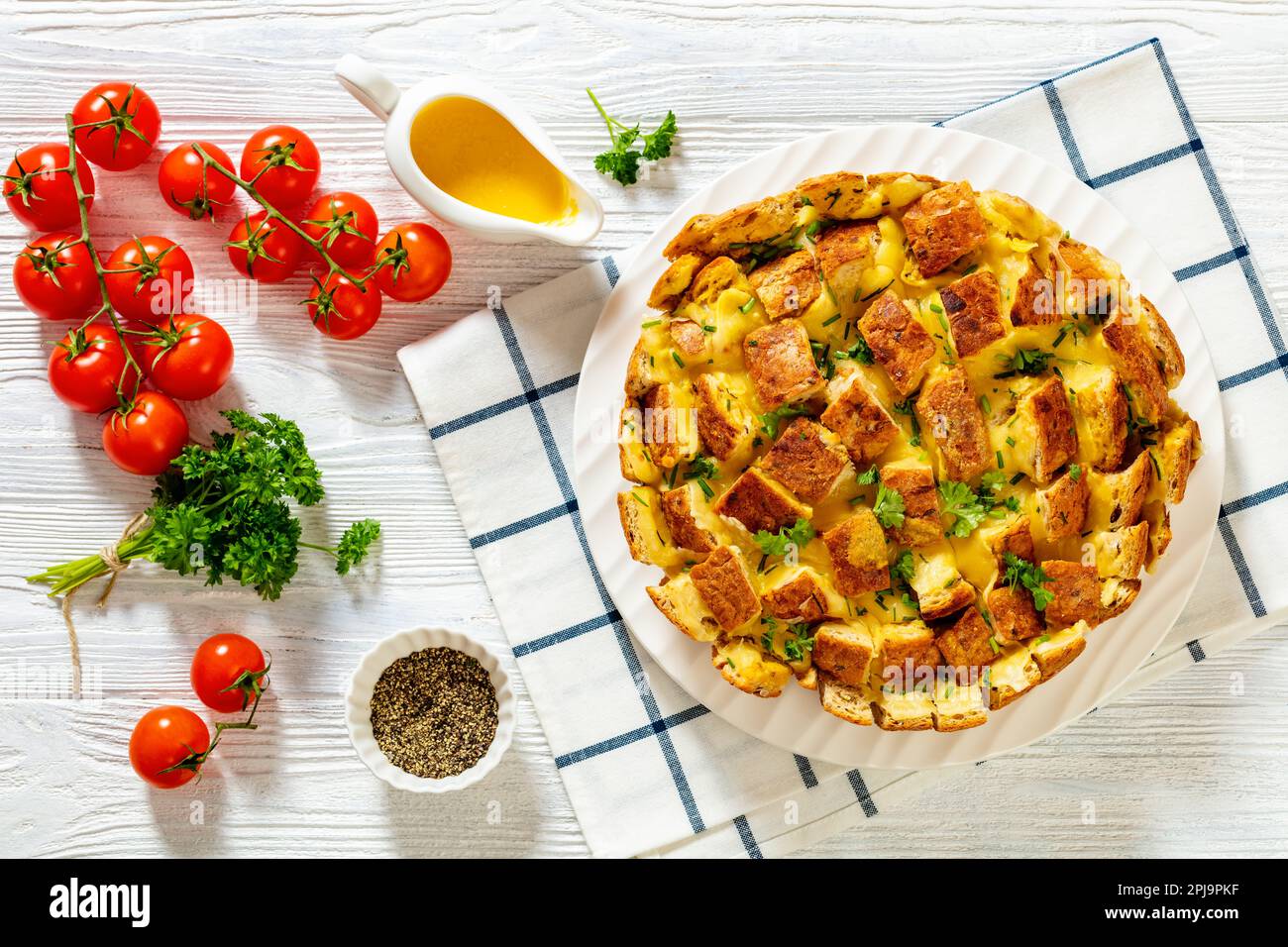 cheesy garlic bread, pull apart whole round bread on platter on white ...