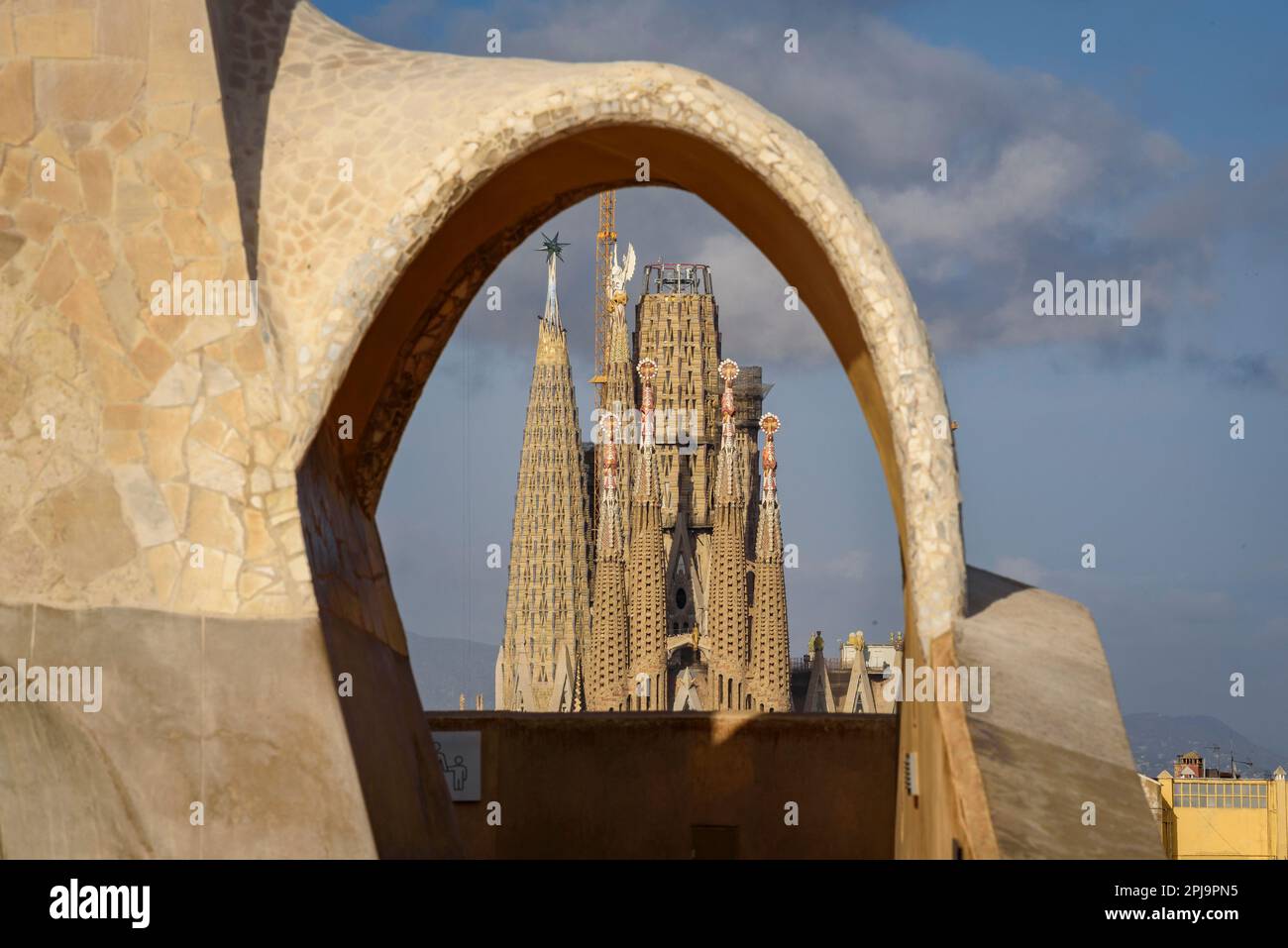 The Passion Facade of the Sagrada Família seen behind an arch of the ...