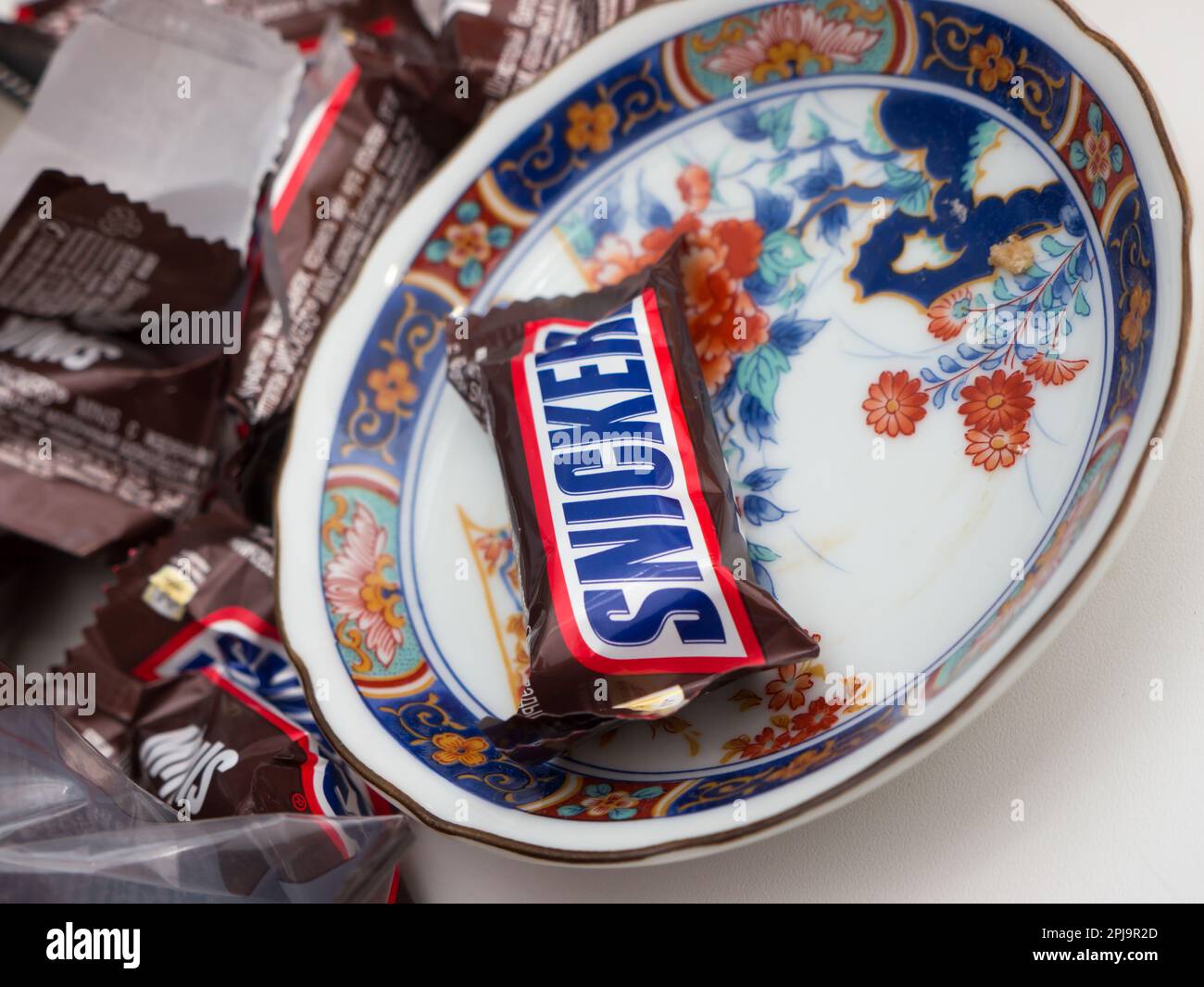 Сhocolate bar Snickers on a brown background Stock Photo - Alamy