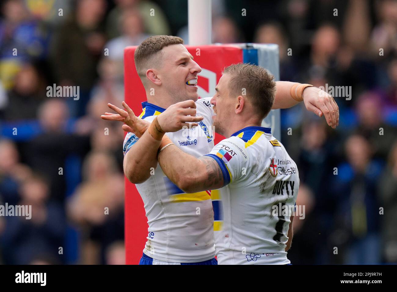 George Williams #6 of Warrington Wolves celebrates with try scorer Matt ...