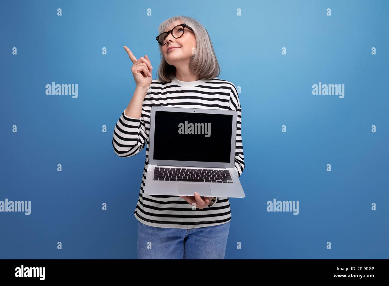 modern middle aged woman holding pc with advertising mockup on bright ...