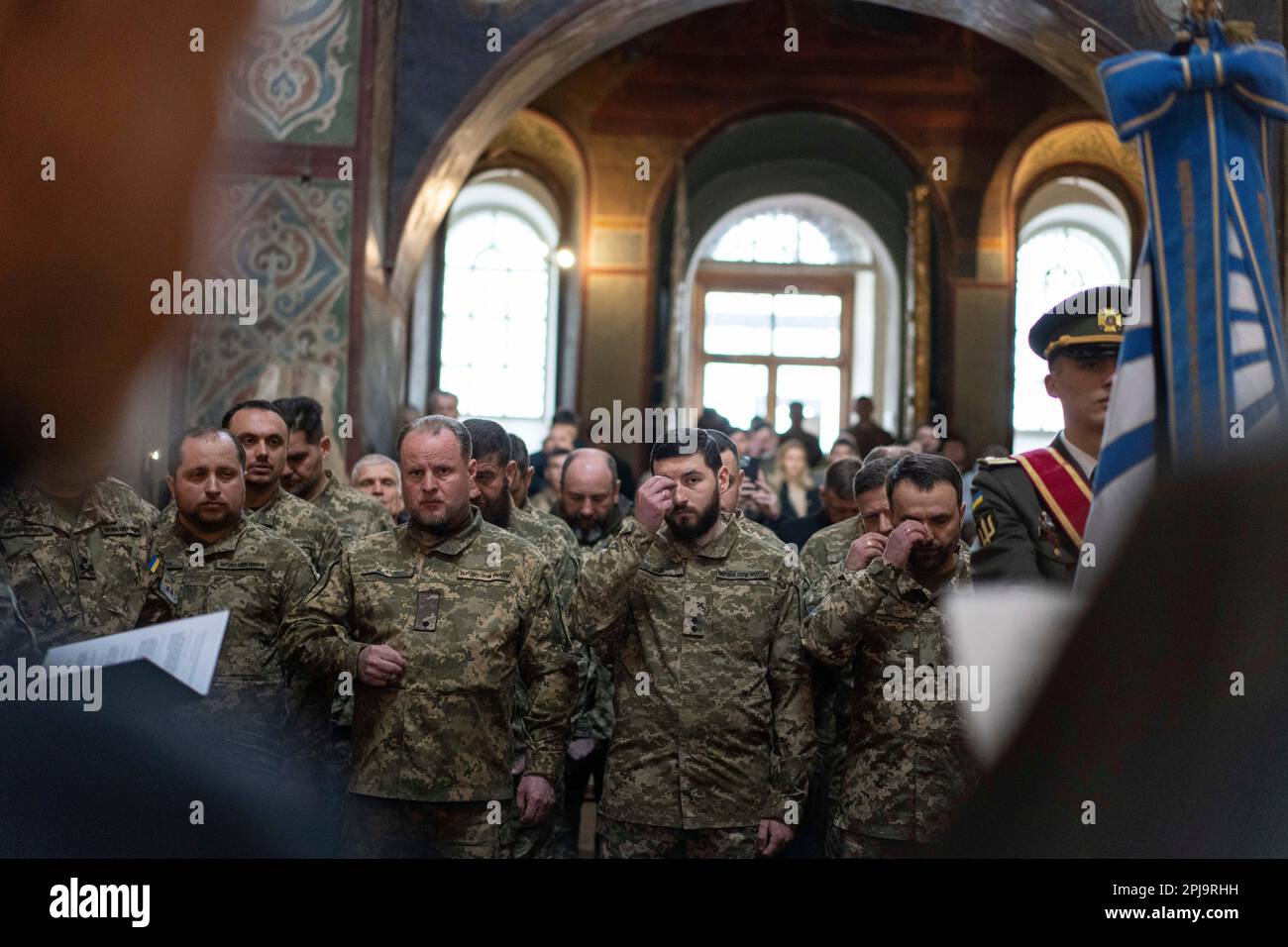 Ukrainian military chaplains make the sign of the cross during the ...
