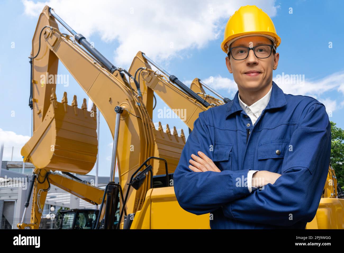 Engineer in a helmet on the background of construction machines.. High ...