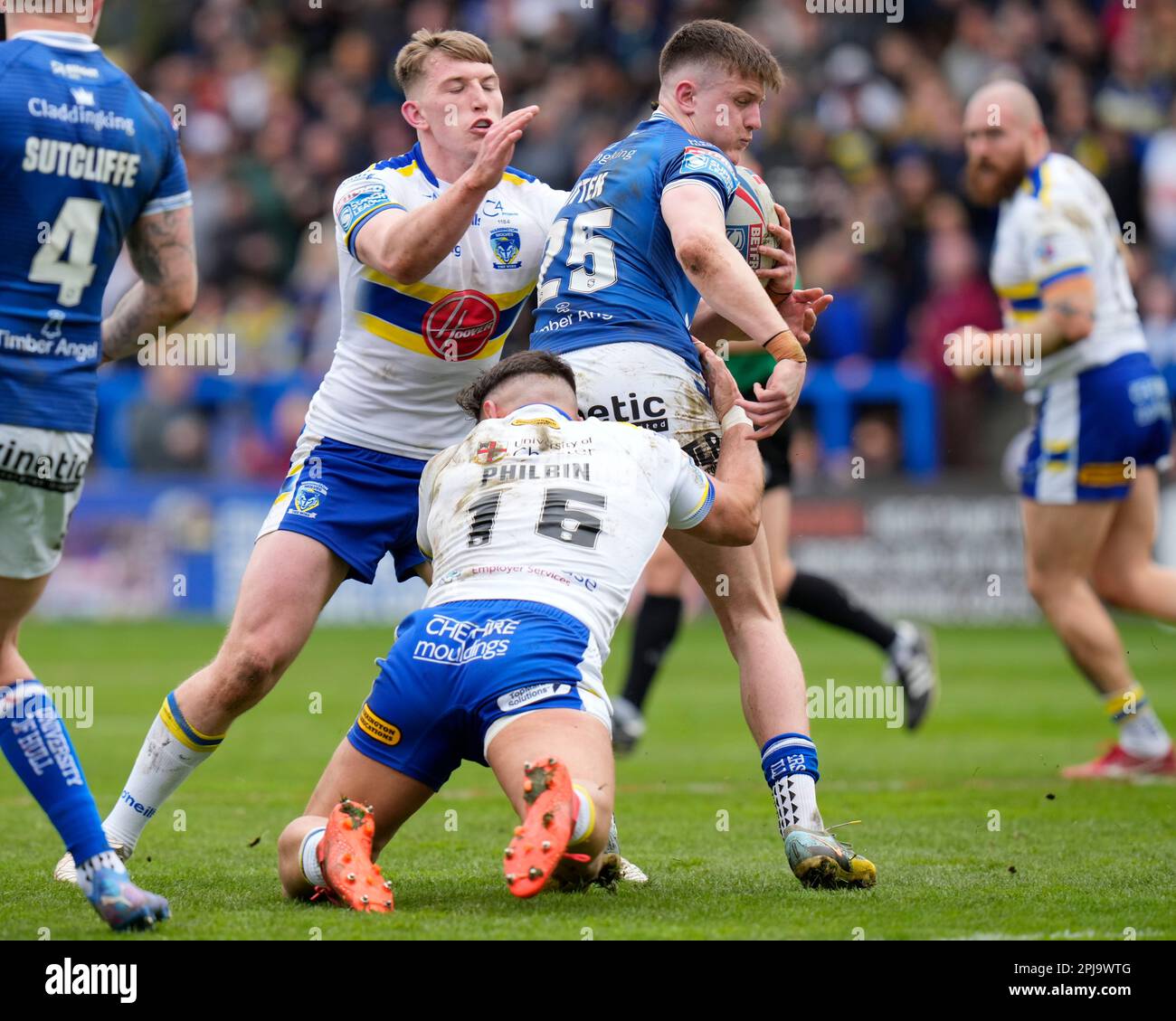Joe Philbin #15 of Warrington Wolves tackles Davy Litten #25 of Hull FC ...