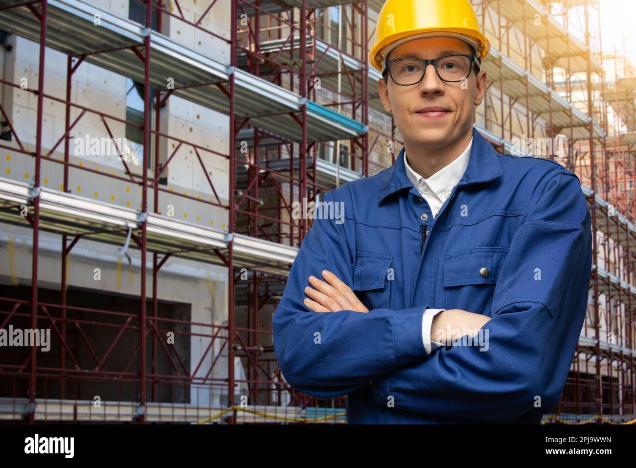 Engineer in a helmet on the background of a building under construction ...