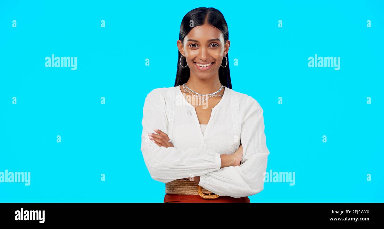 Laughing, studio and Indian woman face with blue background feeling ...
