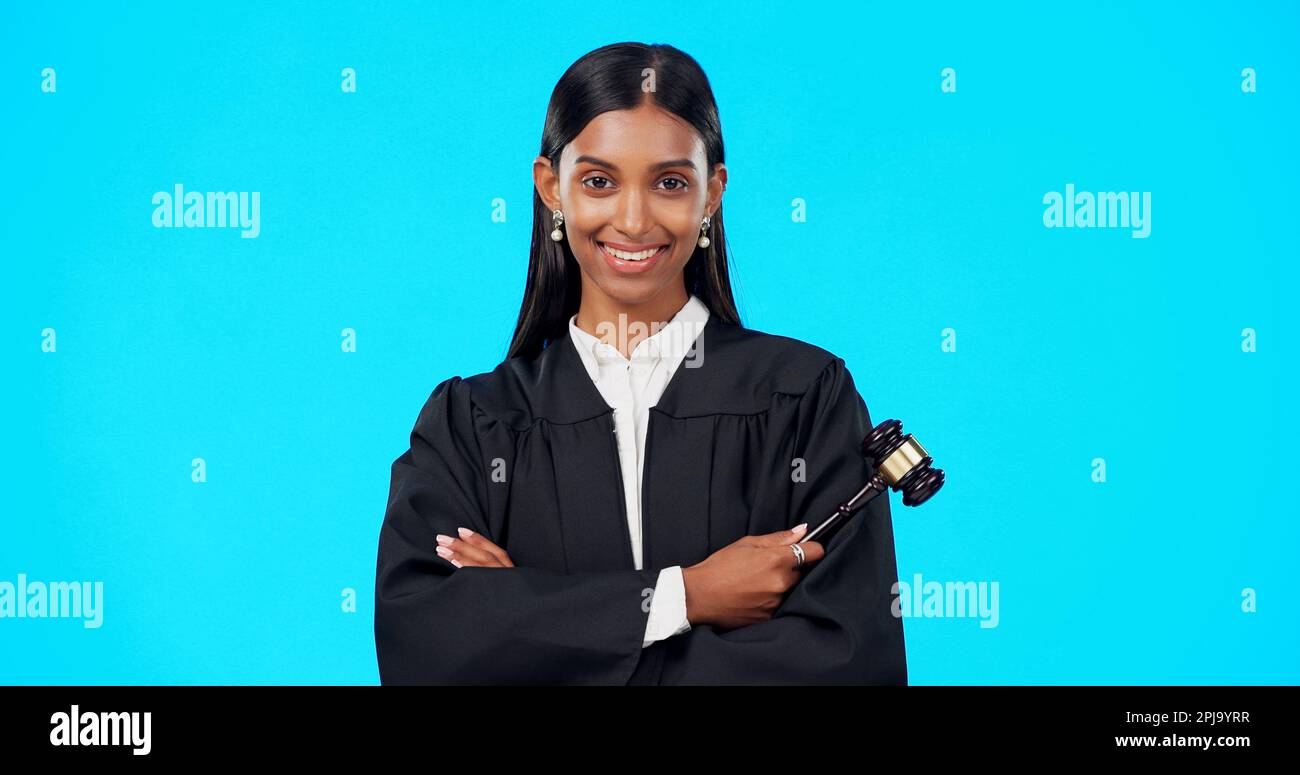 Lawyer, face and happy woman with gavel in studio, blue background and ...