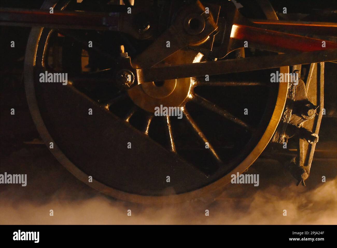 steam locomotive iron wheel with smoke floating on railway in night ...