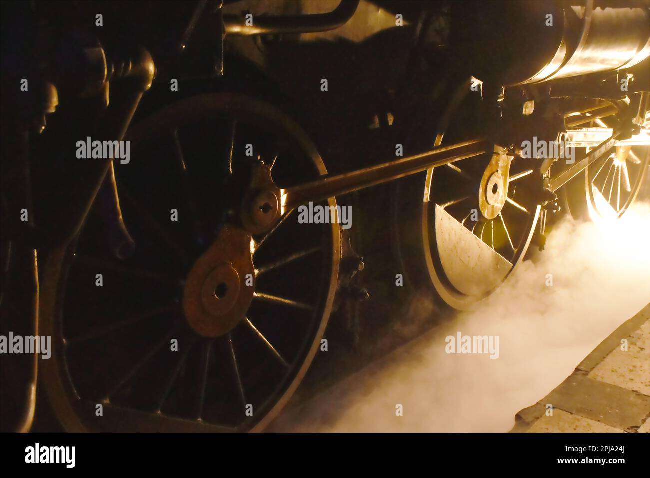 steam locomotive iron wheel with smoke floating on railway in night ...