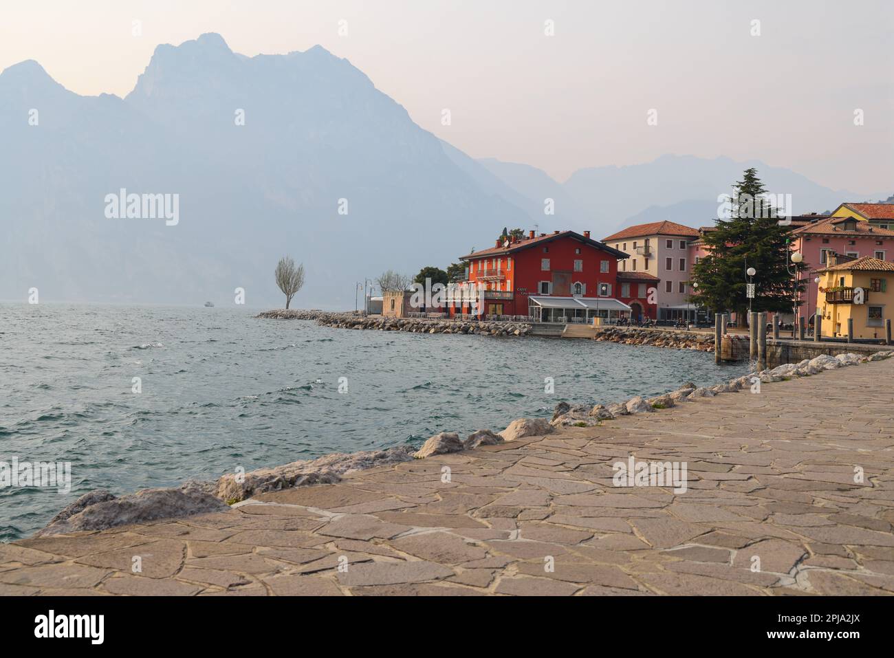 Spring landscape with stone pathway and colorful buildings and ...