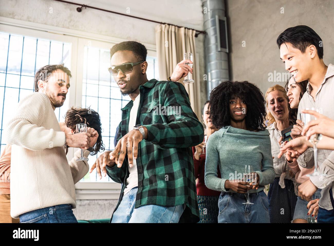 Multi ethnic young friends having home party together - Funny diverse ...